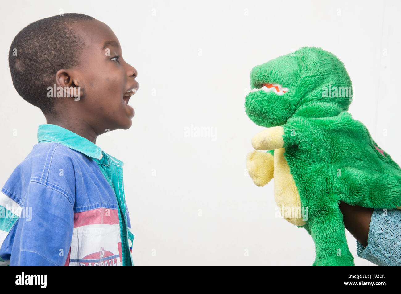 young woman plays with her child taking a toy in hand Stock Photo - Alamy