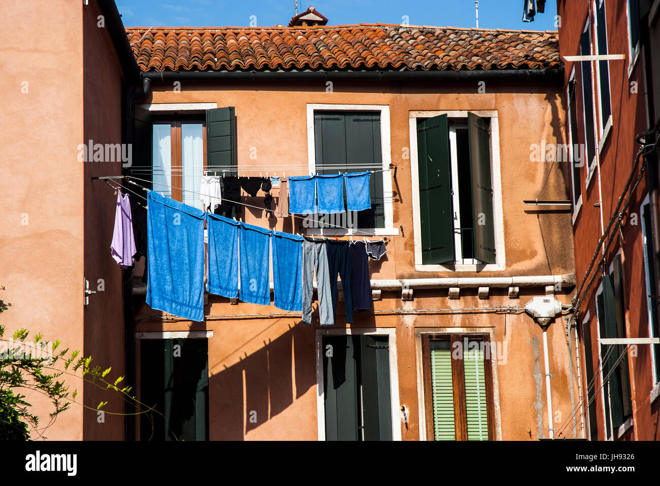 Blue washing drying on washing line outside Venice window Stock Photo ...