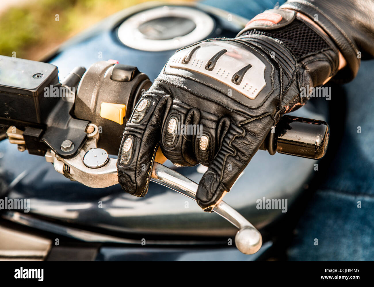 Human hand in a Motorcycle Racing Gloves holds a motorcycle throttle ...