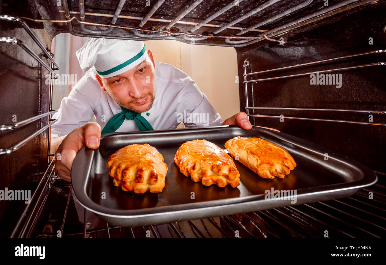 Chef prepares pastries in the oven, view from the inside of the oven ...