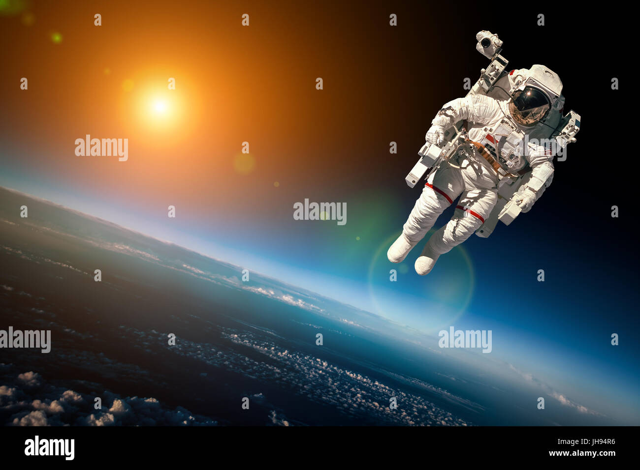 Astronaut in outer space against the backdrop of the planet earth ...