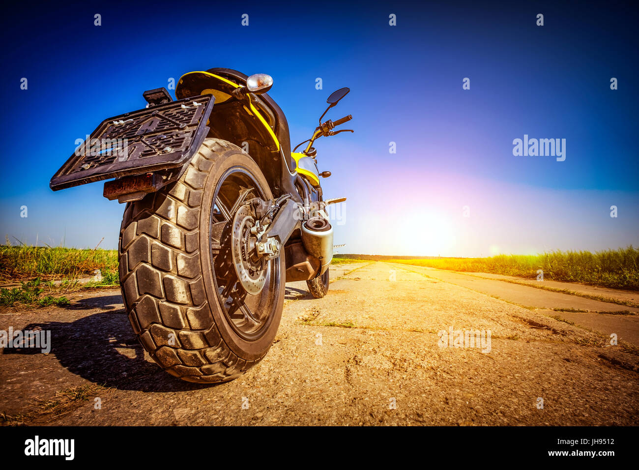 Motorcycle on the road back view Stock Photo - Alamy