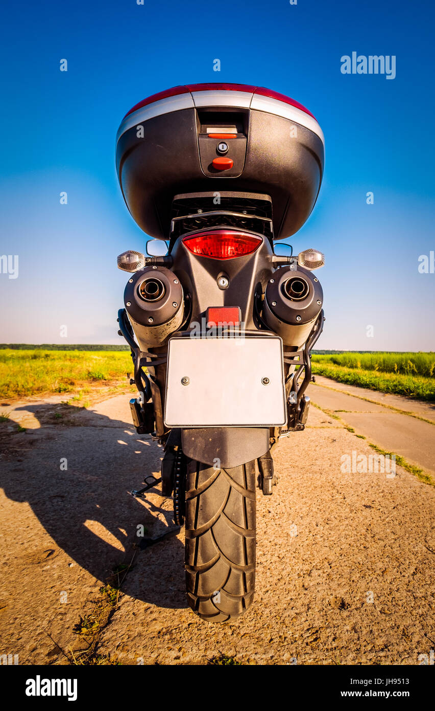 Motorcycle on the road back view Stock Photo - Alamy