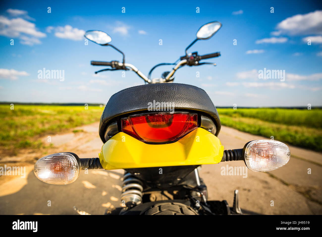 Motorcycle on the road back view Stock Photo - Alamy