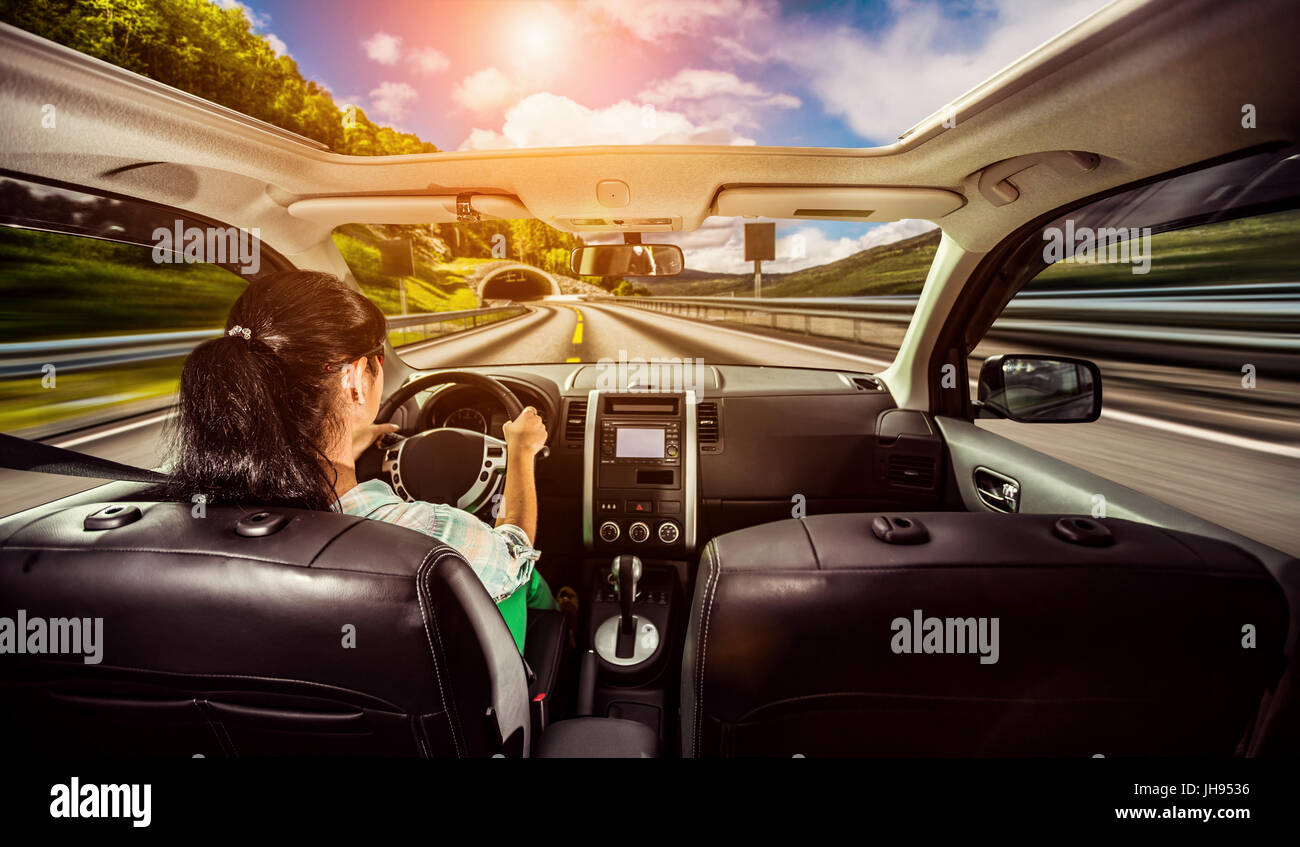 Woman rides on the car at high speed Stock Photo - Alamy