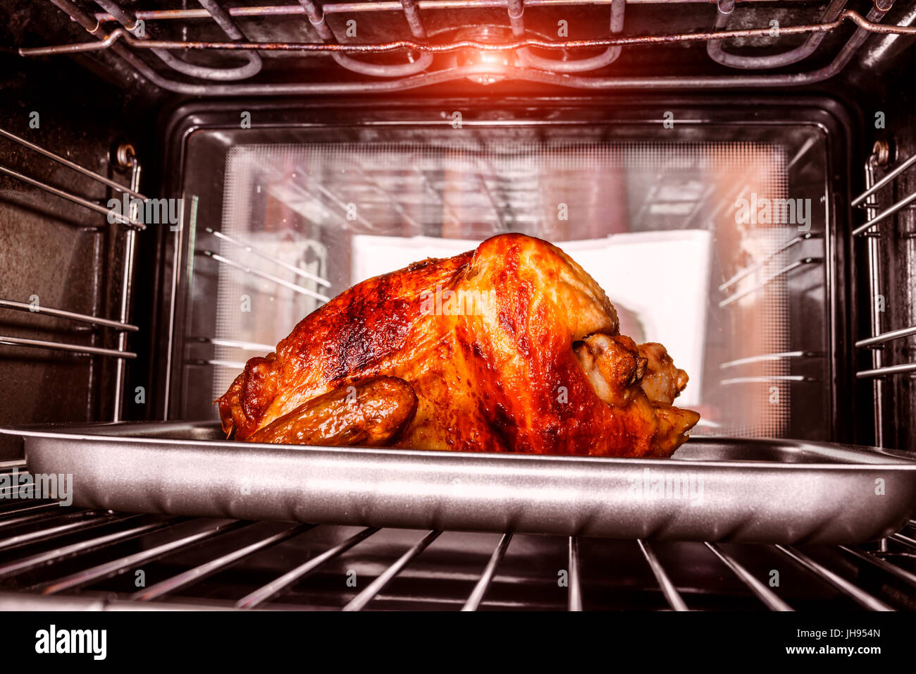 Roast chicken in the oven, view from the inside of the oven. Cooking in ...