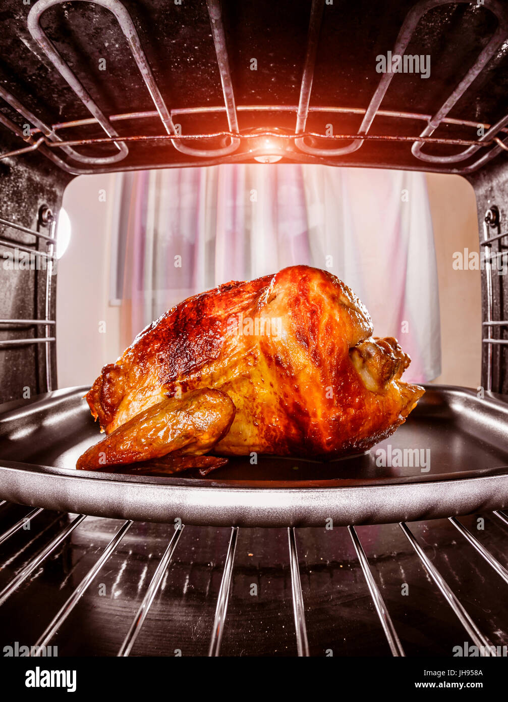 Roast chicken in the oven, view from the inside of the oven. Cooking in ...
