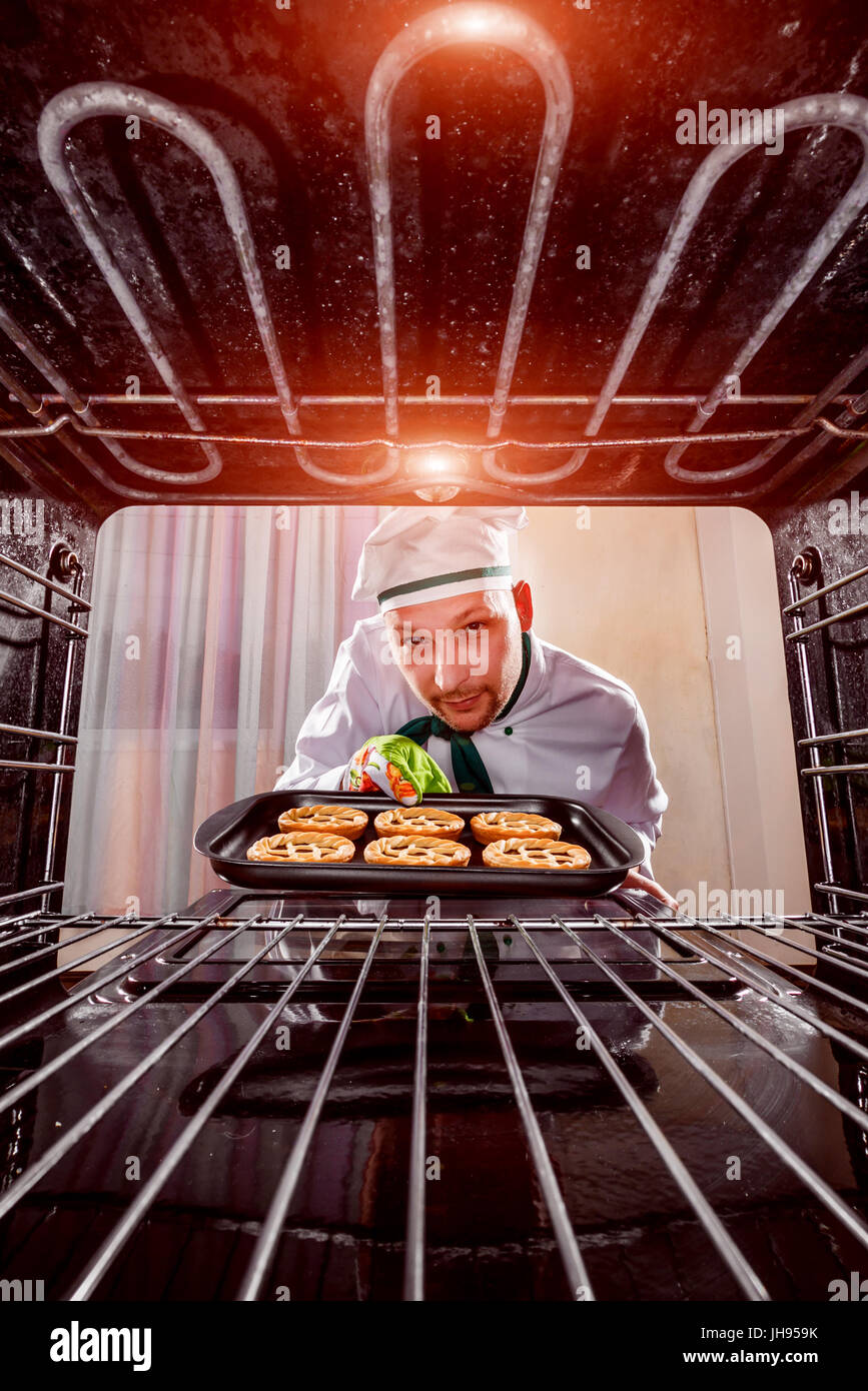 Chef prepares pastries in the oven, view from the inside of the oven ...