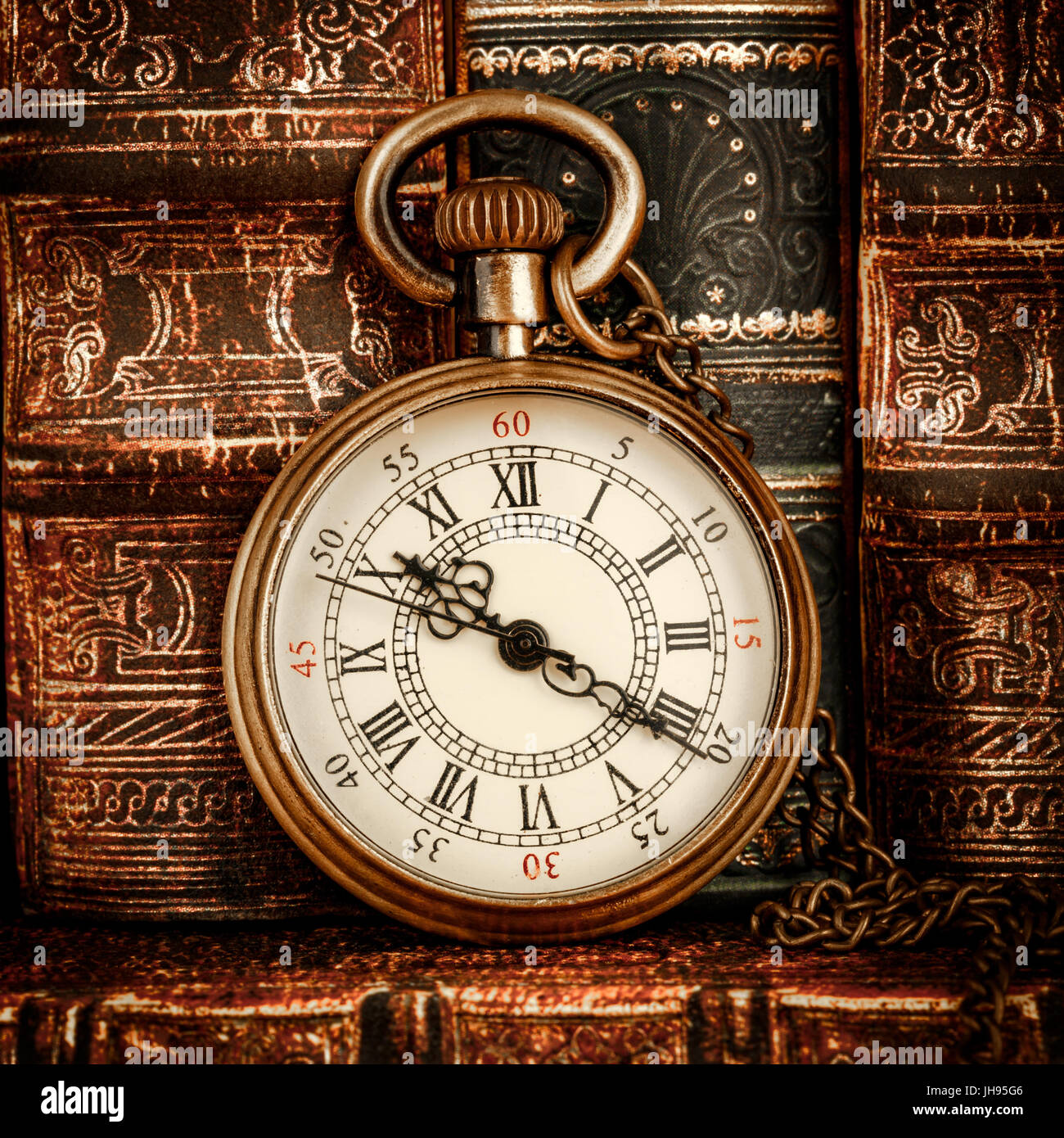 Vintage Antique pocket watch on the background of old books Stock Photo ...