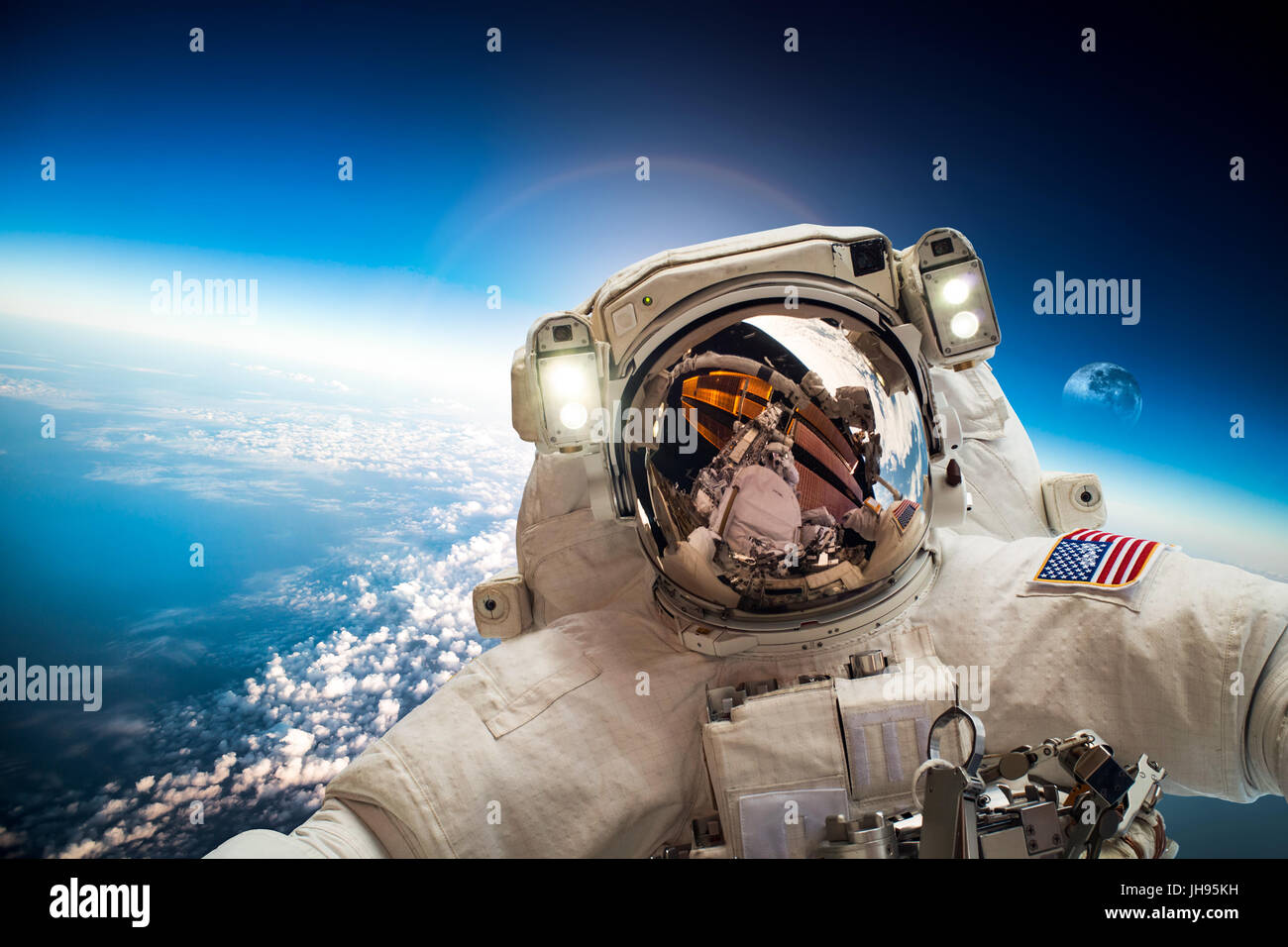 Astronaut in outer space against the backdrop of the planet earth ...