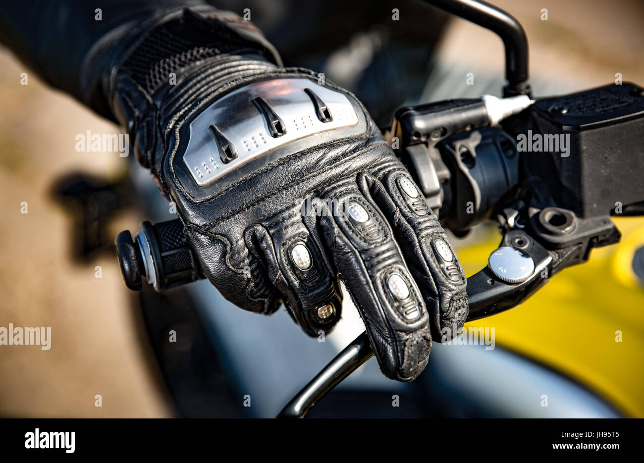 Human hand in a Motorcycle Racing Gloves holds a motorcycle throttle ...
