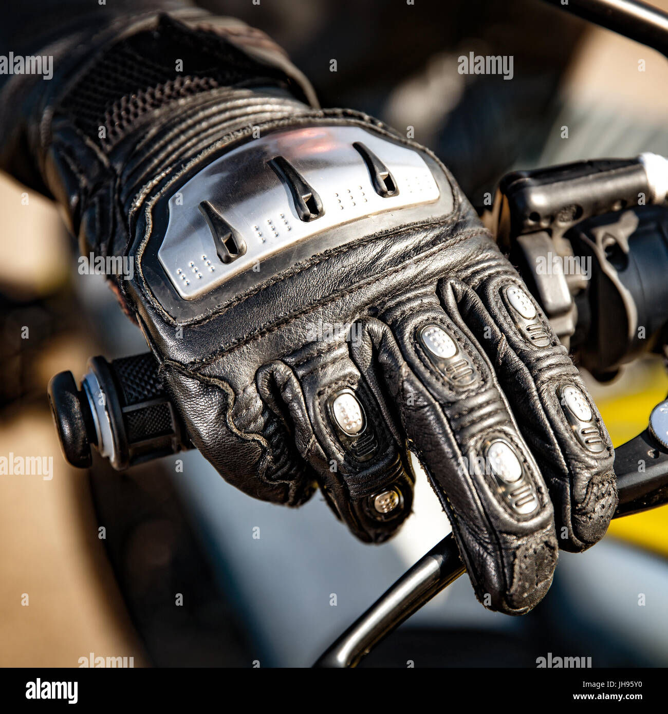 Human hand in a Motorcycle Racing Gloves holds a motorcycle throttle ...