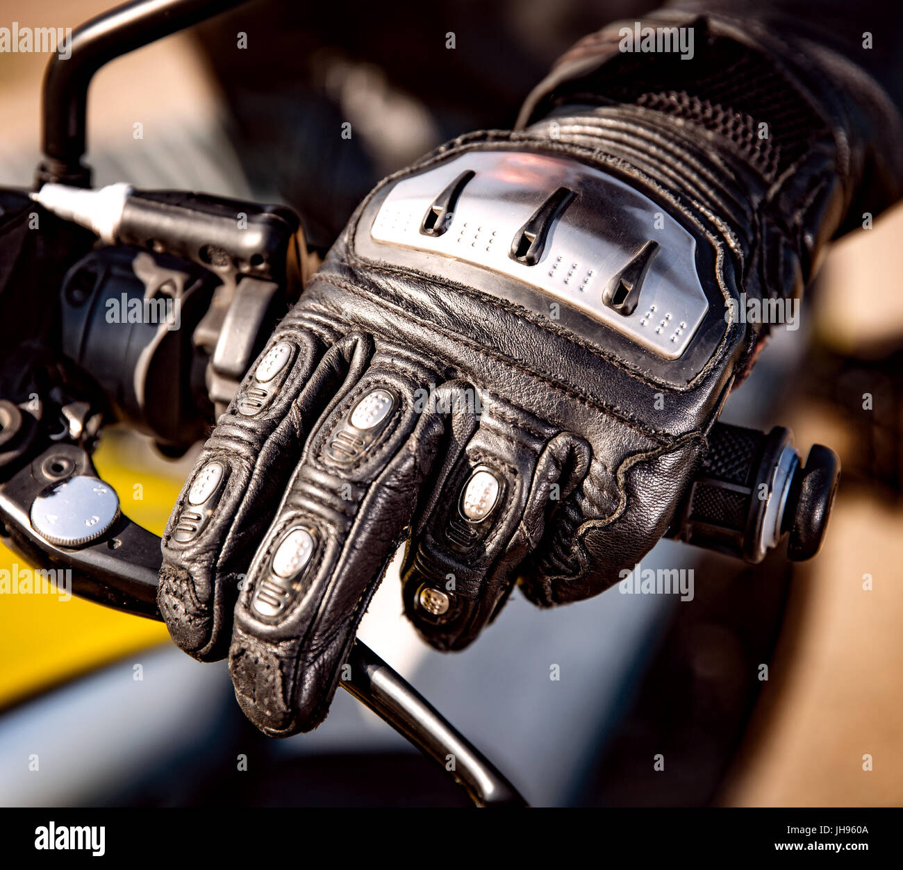 Human hand in a Motorcycle Racing Gloves holds a motorcycle throttle ...
