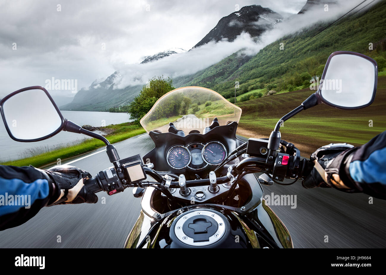 Biker rides a motorcycle in the rain. First-person view Stock Photo - Alamy