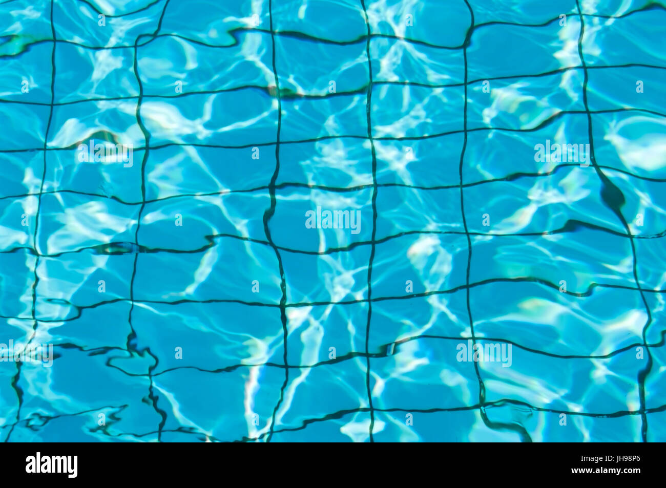 square tiled floor of swimming pool with reflections Stock Photo - Alamy
