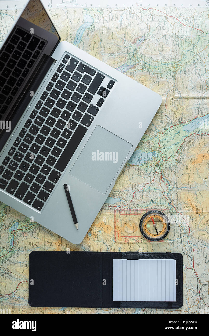 Laptop,map and compass and a notepad Stock Photo - Alamy