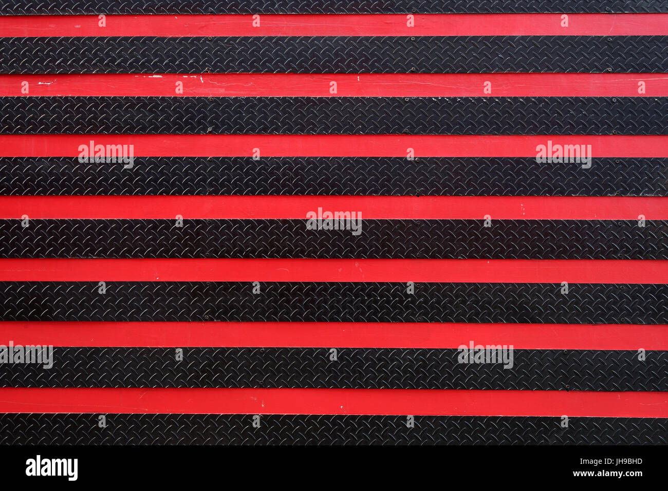 Road background with crossing of red and black road marking and tire ...