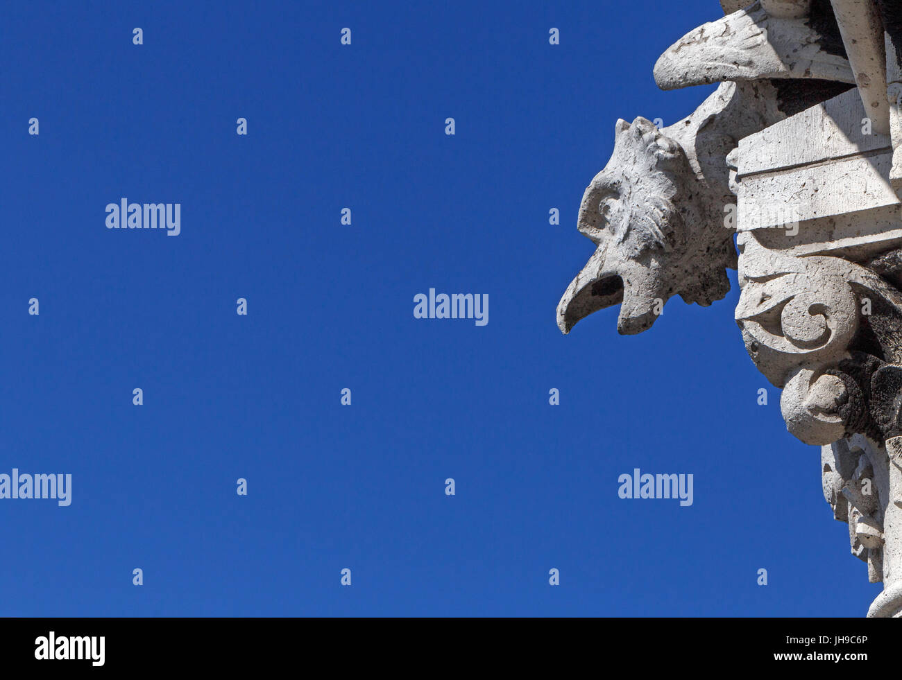 gargoyle on The Basilica of the Sacred Heart of Paris against blue sky ...