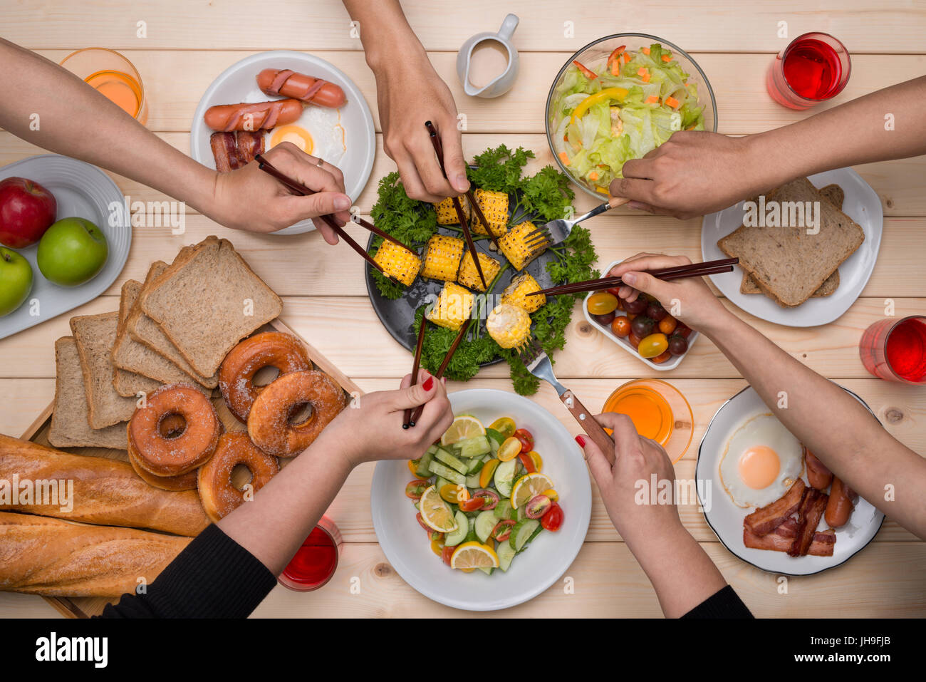 Enjoying dinner with friends. Top view of group of people having dinner ...