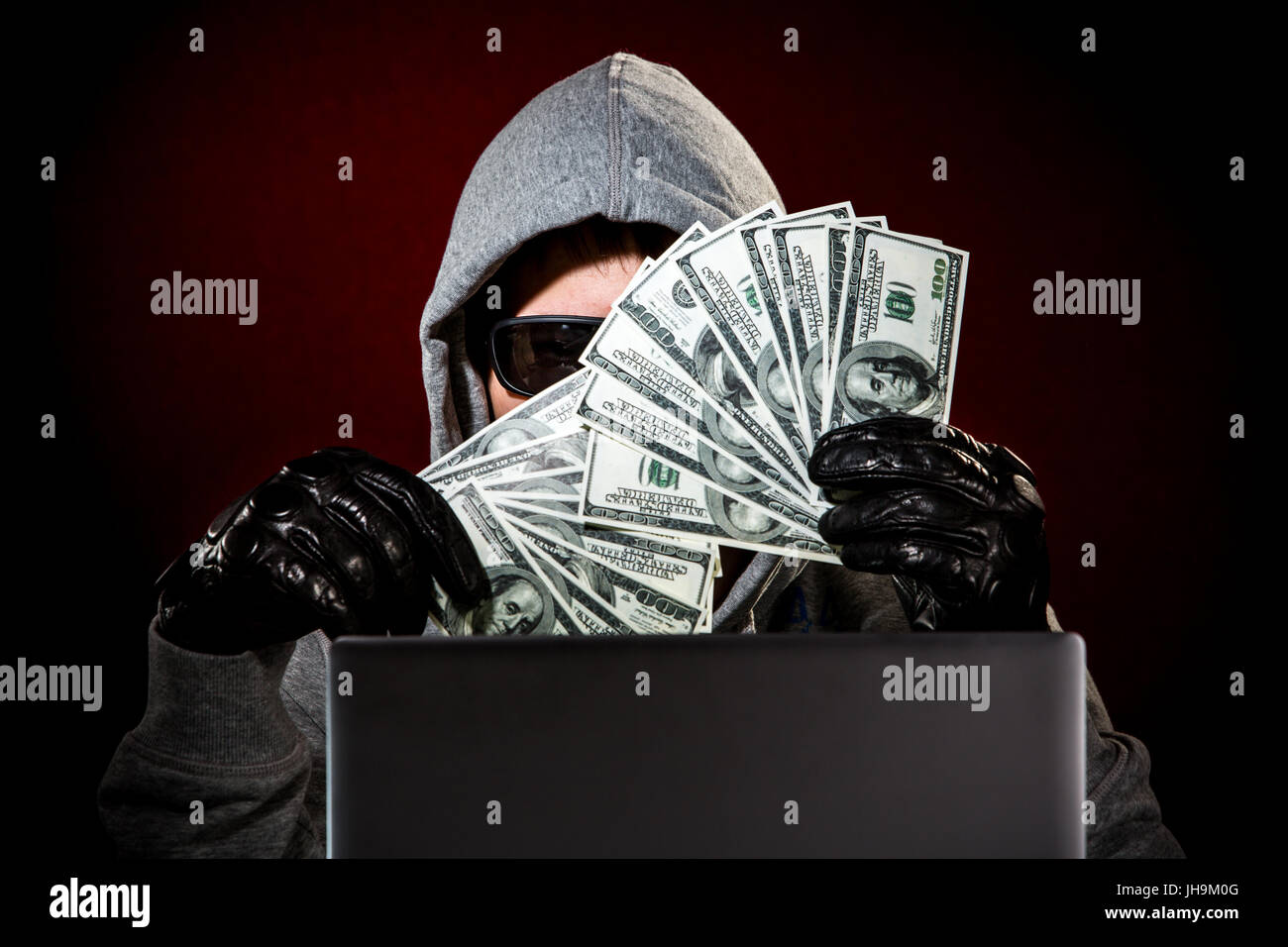 Hacker in a sunglasses with laptop Stock Photo - Alamy