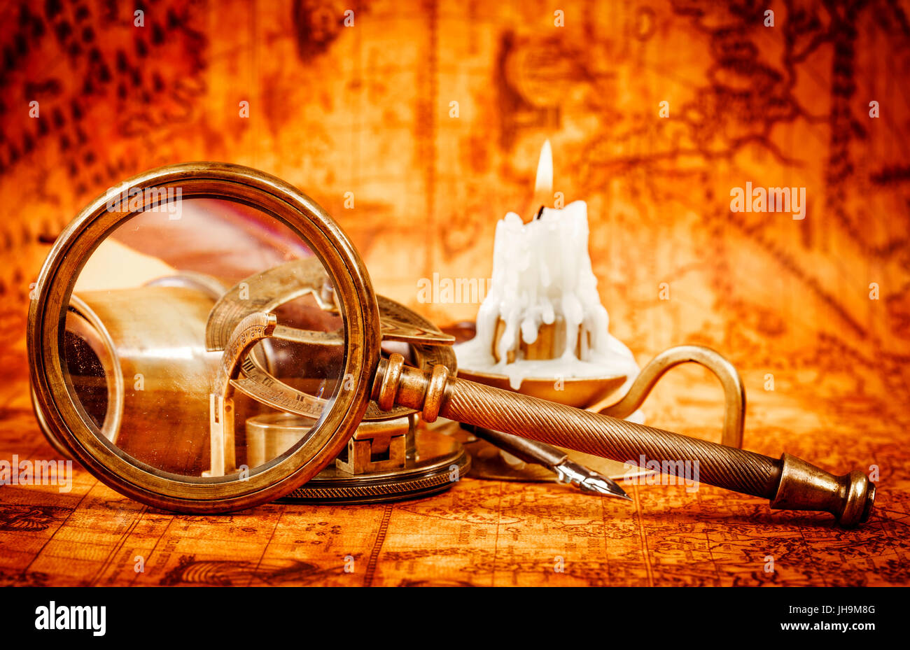 Vintage still life. Vintage magnifying glass lies on an ancient world ...