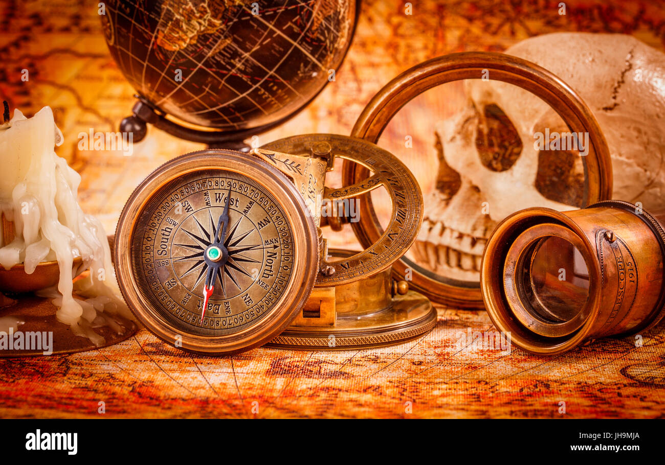 Vintage still life. Vintage magnifying glass lies on an ancient world ...