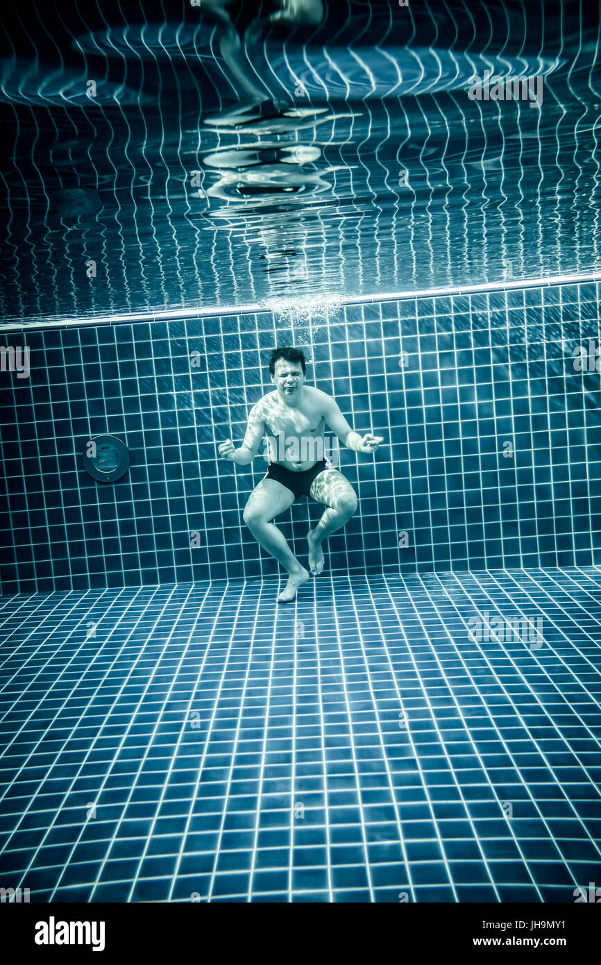 Man standing under water in a swimming pool Stock Photo - Alamy