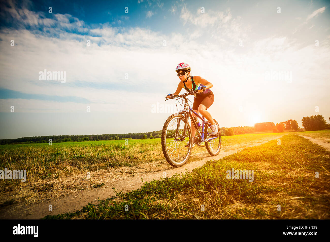 Women on the nature of riding a bike Stock Photo - Alamy