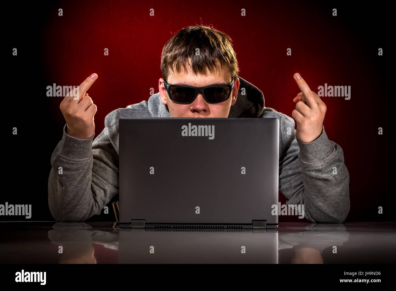 Hacker in a sunglasses with laptop Stock Photo - Alamy
