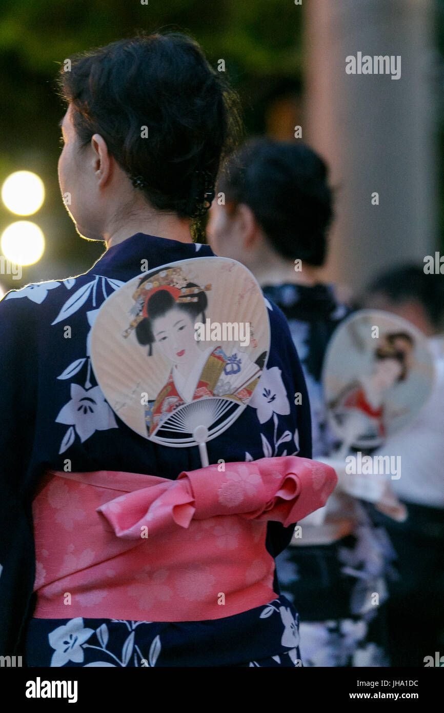 Visitors dressed in traditional Japanese clothing dance during the ...