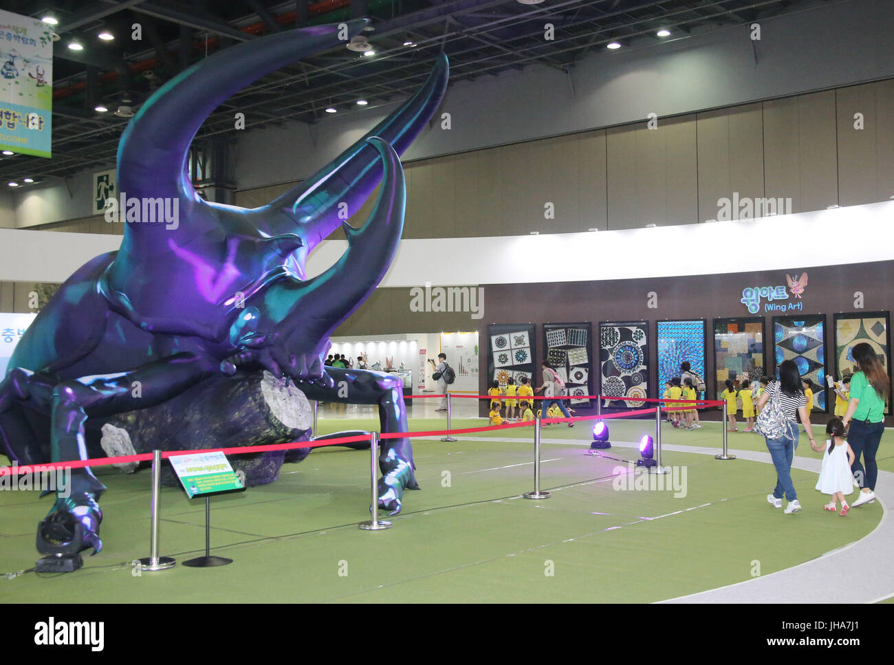 Insect fair opens Visitors look at a giant beetle sculpture on display ...