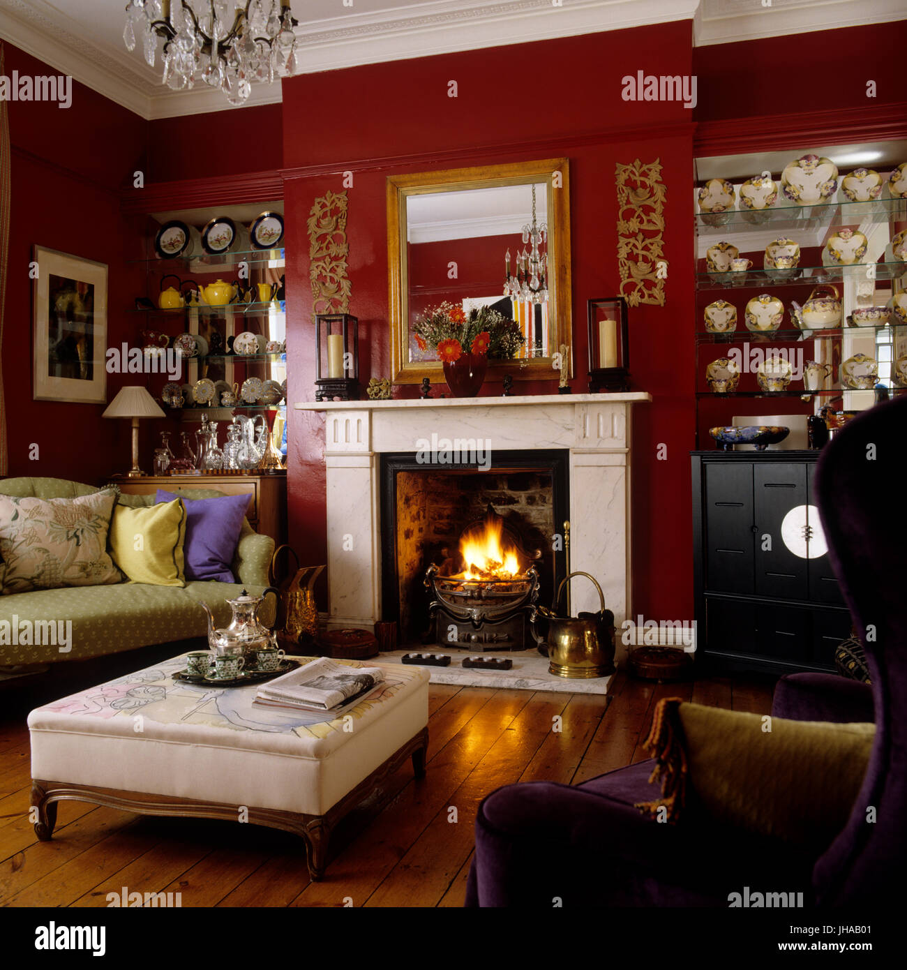 Lit fireplace in living room Stock Photo - Alamy