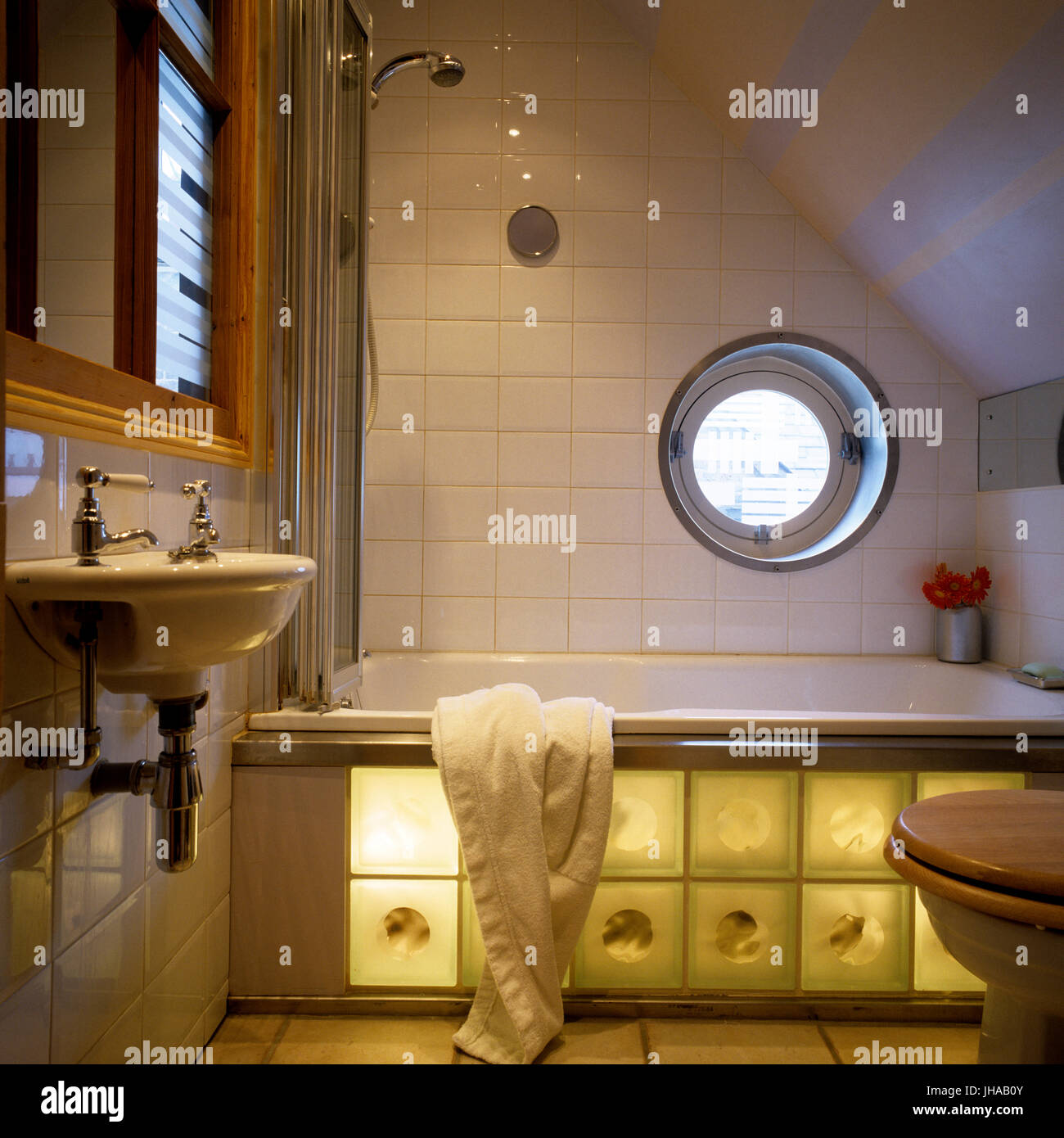 Modern bathroom with circular window Stock Photo - Alamy