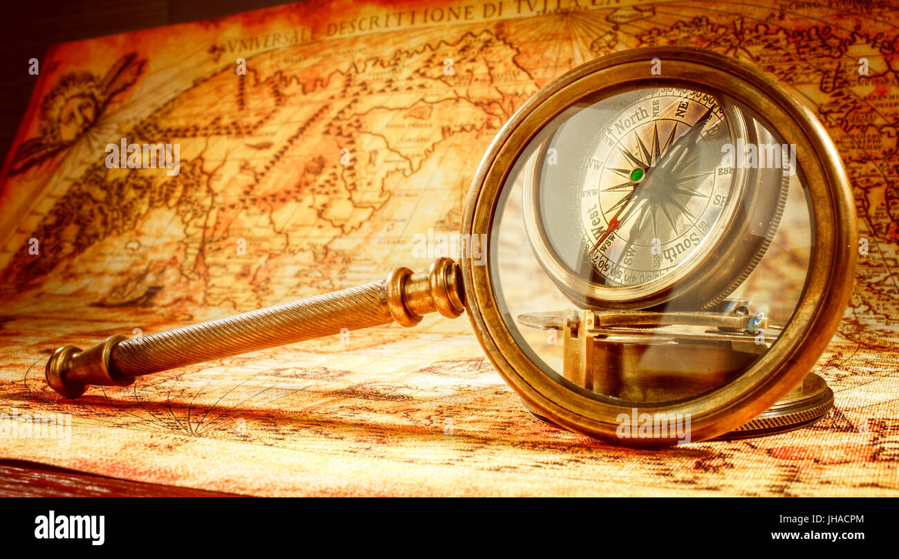 Vintage still life. Vintage magnifying glass lies on an ancient world ...