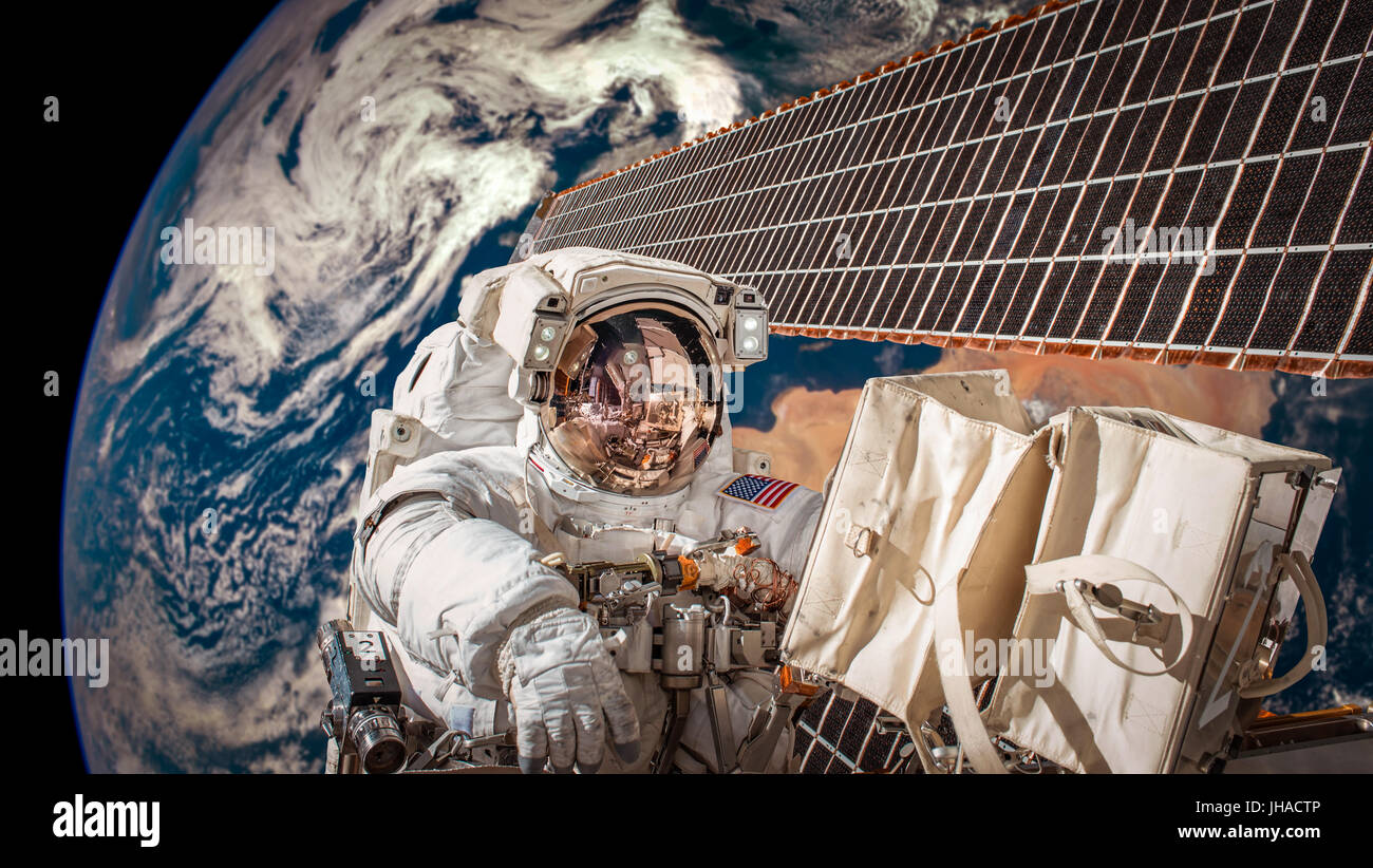 International Space Station and astronaut in outer space over the ...