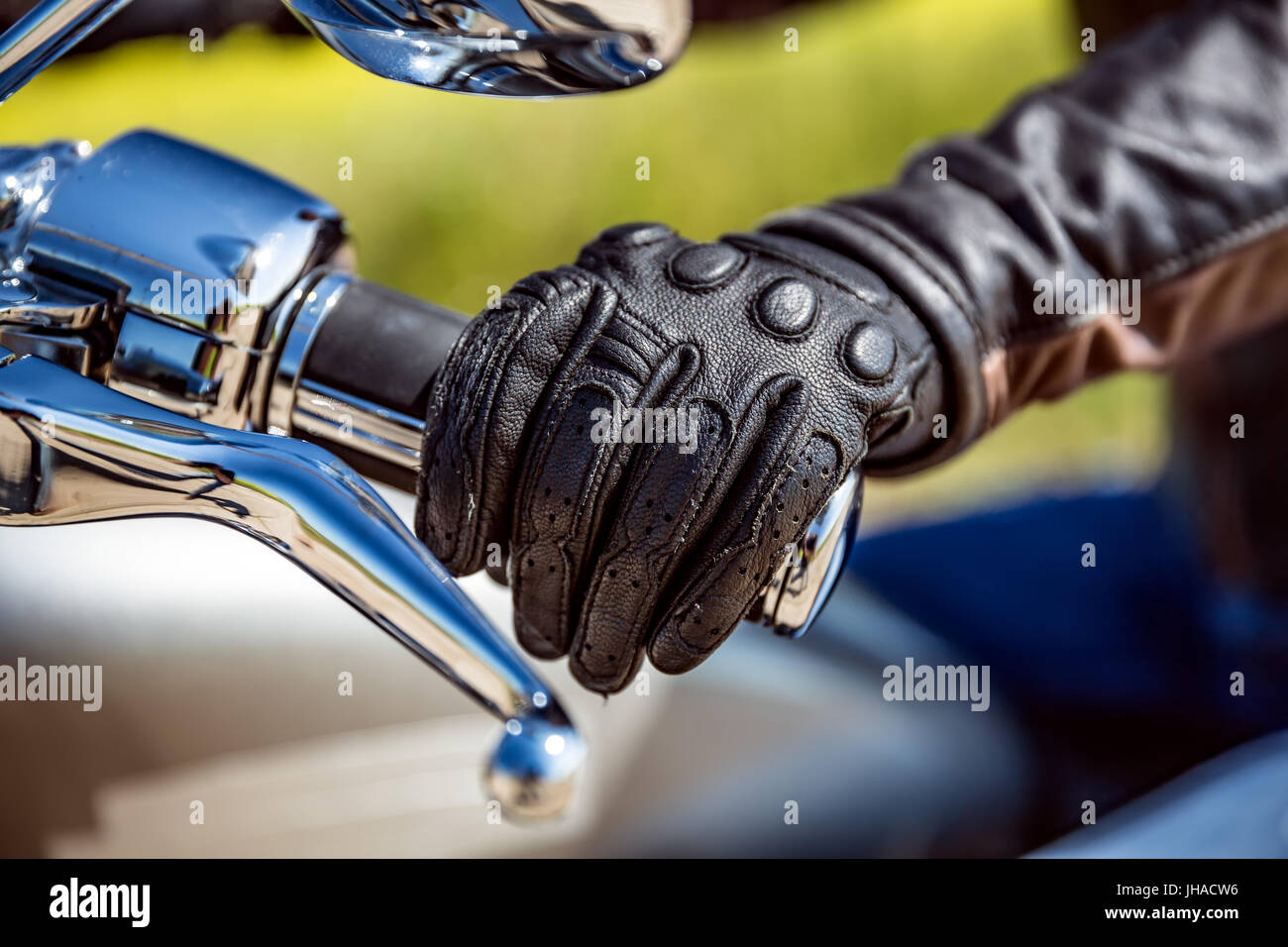 Human hand in a Motorcycle Racing Gloves holds a motorcycle throttle ...