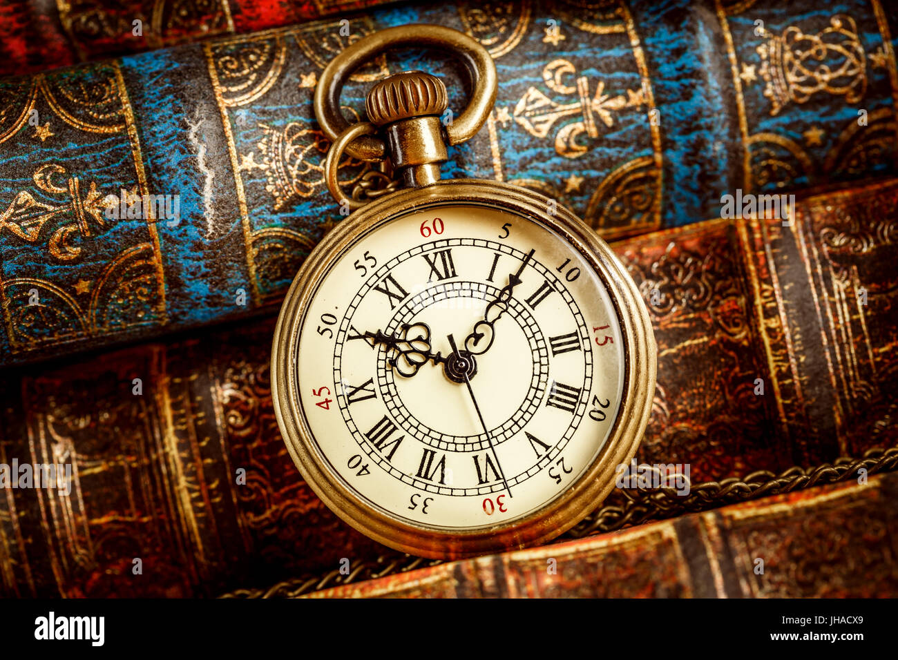 Vintage Antique pocket watch on the background of old books Stock Photo ...
