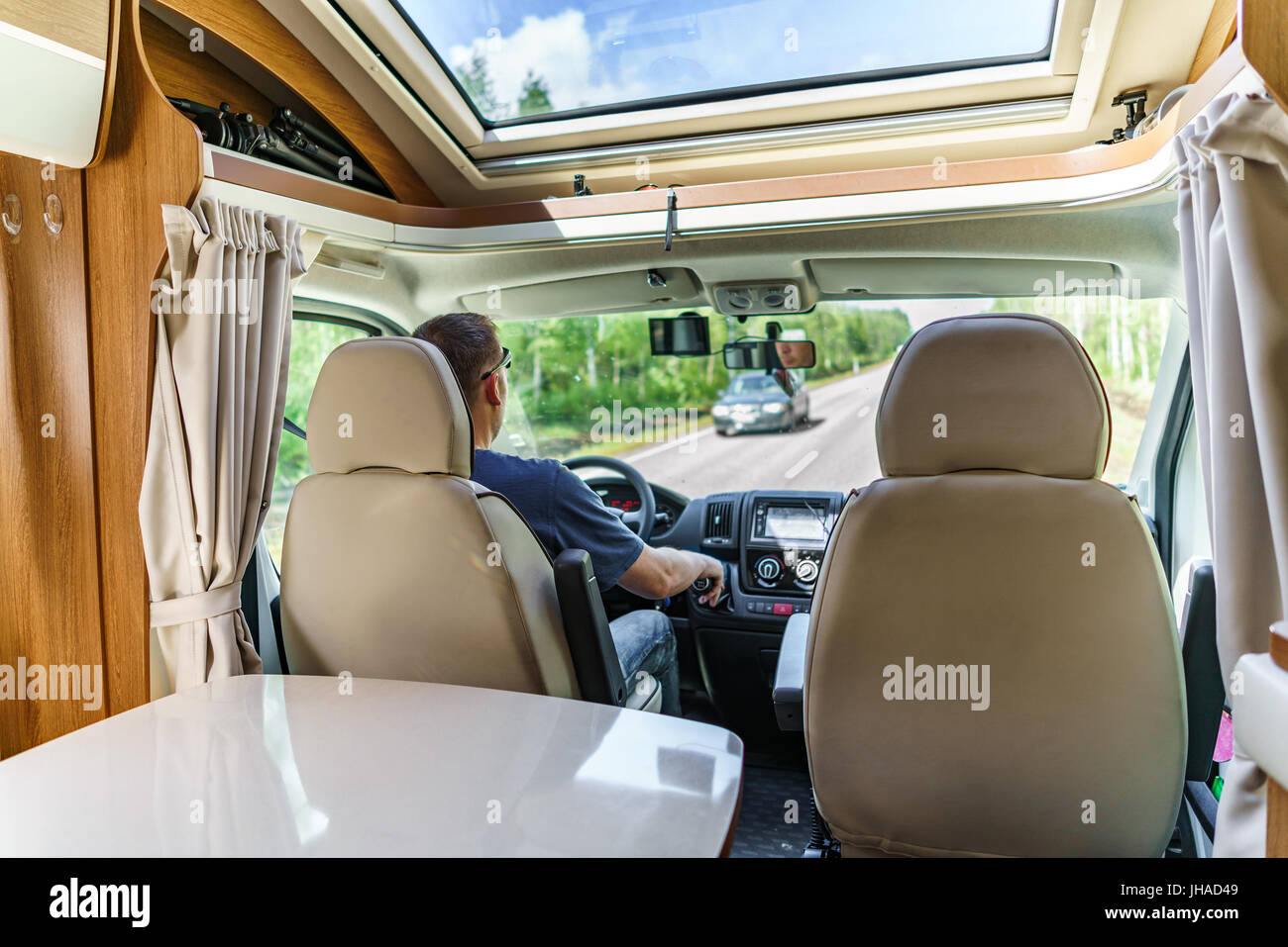 Man driving on a road in the Camper Van. Caravan car Vacation. Family ...