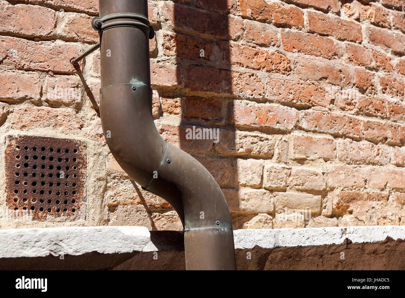old rain gutter on a brick wall home Stock Photo - Alamy