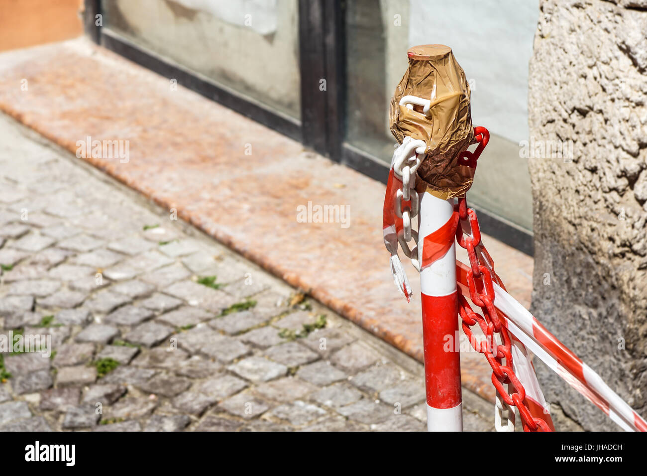 White and red baton used to define a working area Stock Photo - Alamy