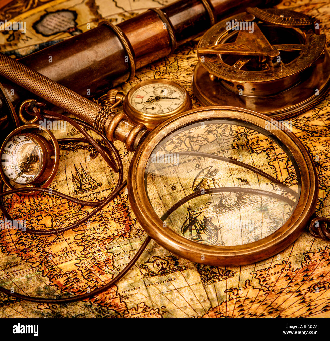 Vintage still life. Vintage magnifying glass lies on an ancient world ...