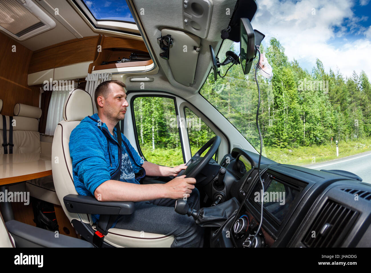 Man driving on a road in the Camper Van. Caravan car Vacation. Family ...