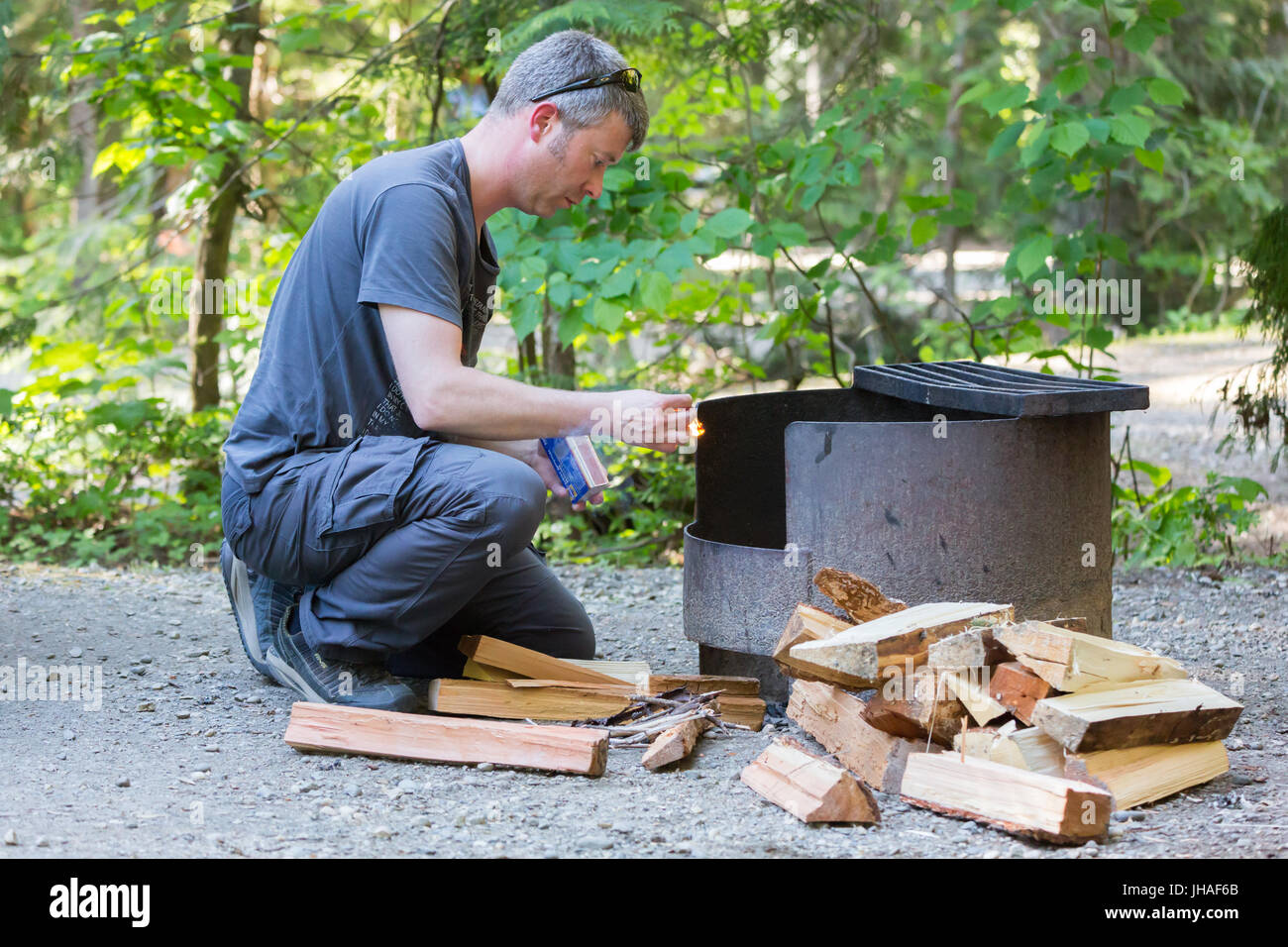 Lighting a campfire with a match hi-res stock photography and images ...