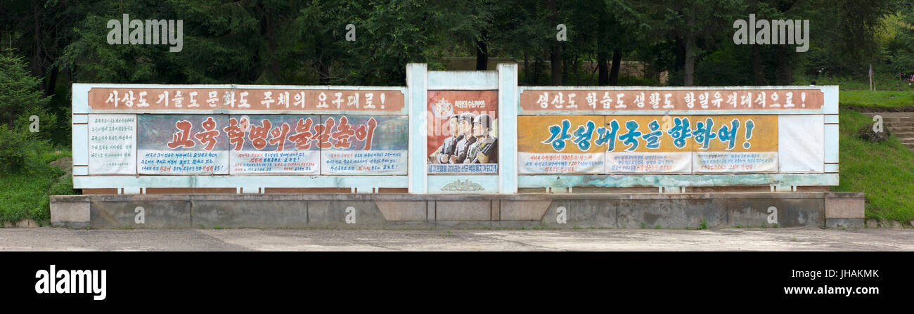 Inspirational poster and slogan on wall in Pochonbo. DPRK / North Korea ...