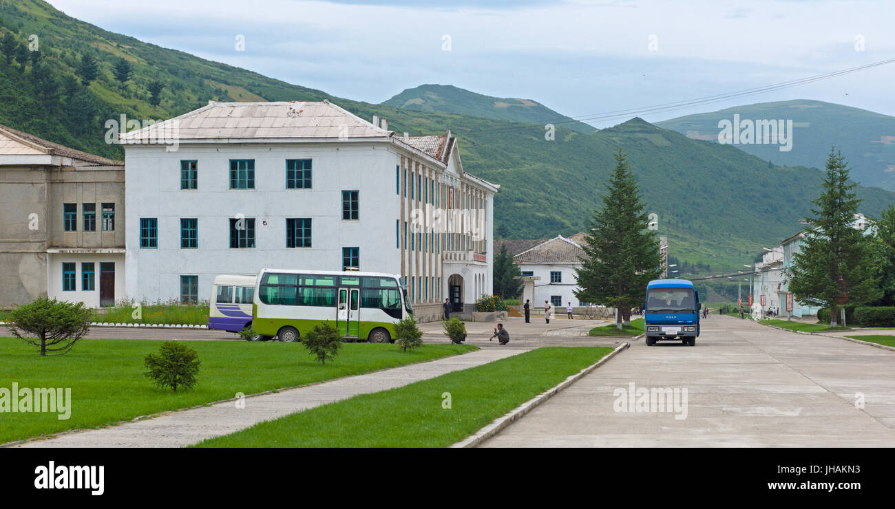 Tour and other mini buses parked in Pochonbo near public building. DPRK ...