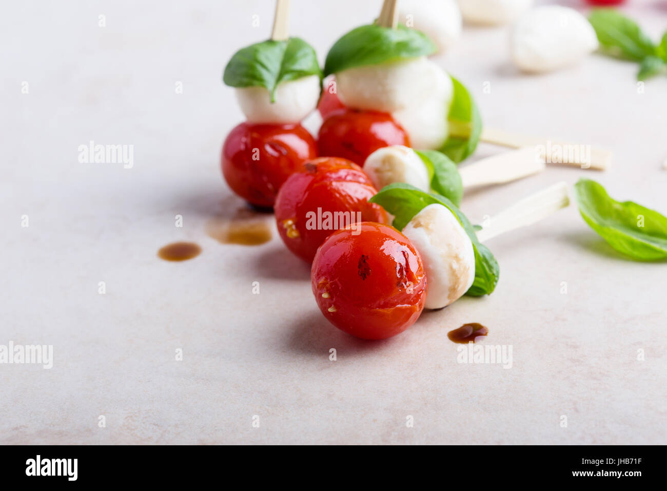 Grilled caprese kebabs on light grey background, traditional Italian ...