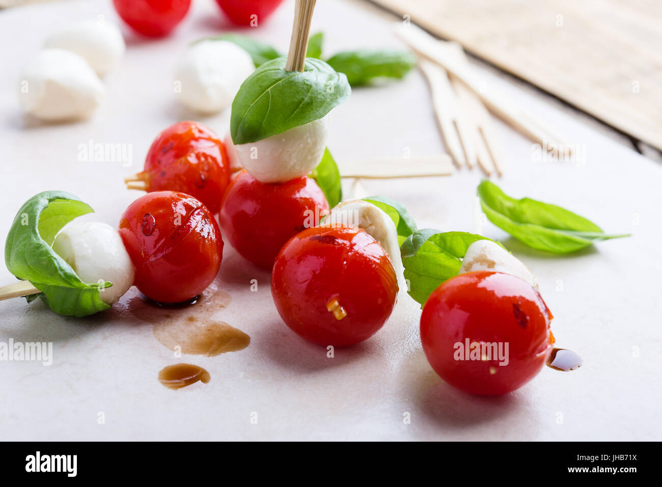 Grilled caprese kebabs on light grey background, traditional Italian ...