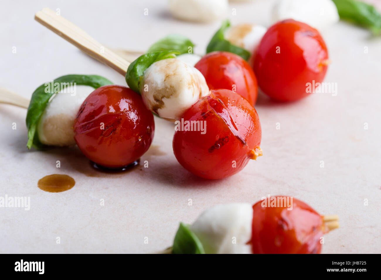 Grilled caprese kebabs on light grey background, traditional Italian ...