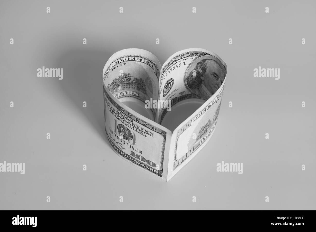 Dollar US bills in heart shape Stock Photo - Alamy