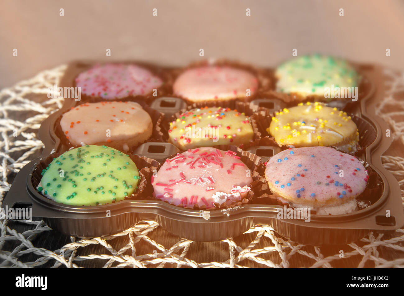 Small round multi-colored cakes in the sun. The horizontal frame Stock ...